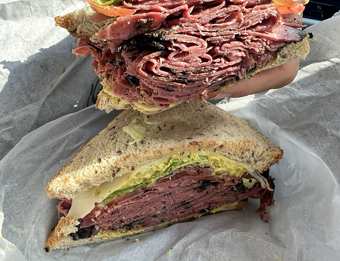 Some pastrami sandwiches make promises they can't keep – this towering beauty delivers an experience so good you'll consider moving to Norwood just to be closer.