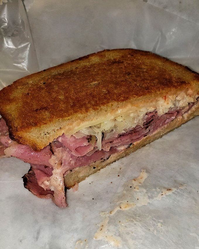 Pastrami so perfectly stacked it deserves its own architectural award. The bread is just there to give your hands something to hold.