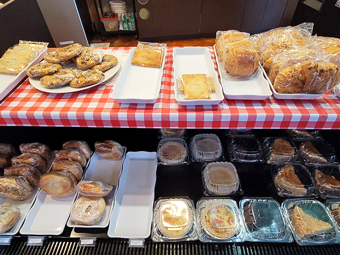 Pastry paradise awaits the indecisive. This display case is where good intentions about "just having coffee" go to surrender deliciously.