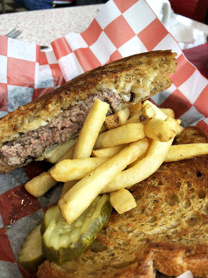 The patty melt&mdash;that perfect marriage of beef, cheese, and grilled bread&mdash;flanked by fries so golden they deserve their own Swiss bank account.