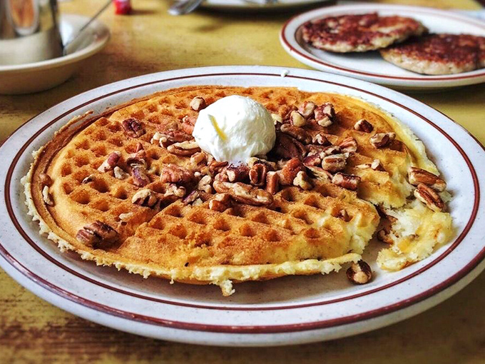 The pecan waffle arrives like edible architecture&mdash;crisp exterior, fluffy interior, with nuts that add just the right crunch. That butter pat melts with purpose.