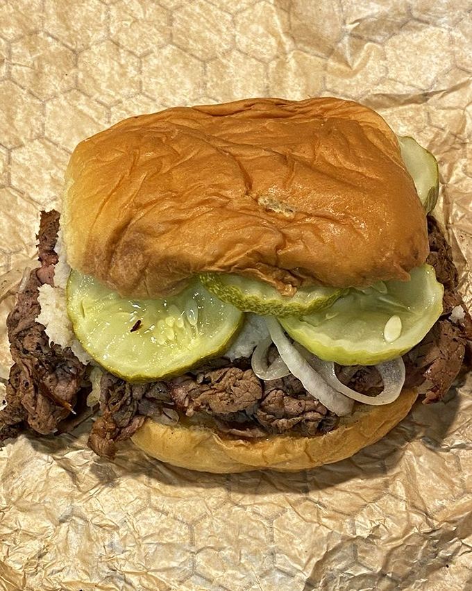 The classic pit beef sandwich in all its glory &ndash; thinly sliced, perfectly pink meat piled high on a kaiser roll with raw onions and pickles. Baltimore's answer to the cheesesteak.