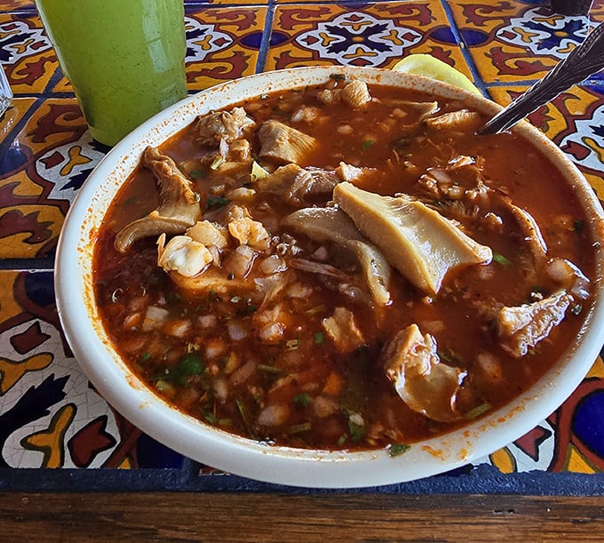 This hearty menudo isn't just soup&mdash;it's a restorative experience. That green drink alongside? The perfect cooling companion for this rich, spicy bowl.