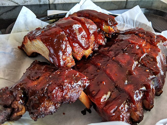 These glossy, mahogany ribs glisten with sauce like edible jewels that would make any pitmaster weep with envy.