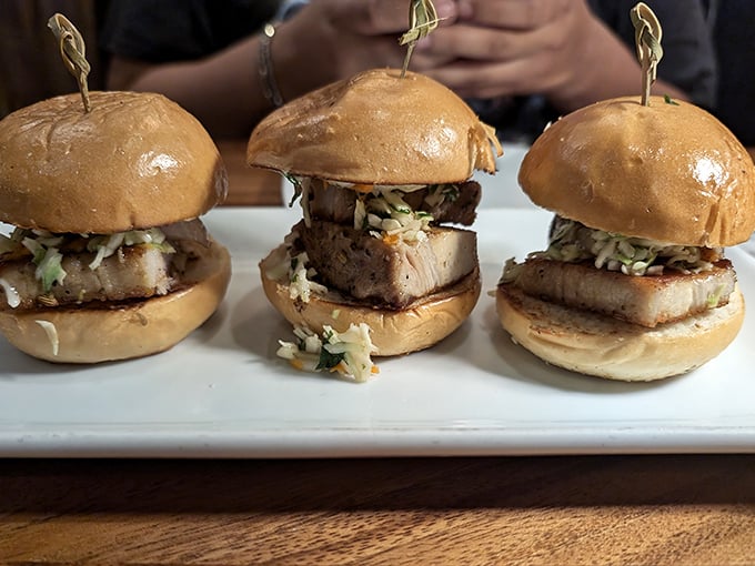 These pork belly sliders aren't just appetizers—they're three perfect bites of happiness. The kind of food that makes you close your eyes and ignore your dining companions.