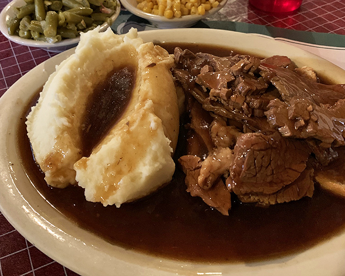 Pot roast that falls apart at the mere suggestion of a fork, swimming in gravy that should be bottled and sold as therapy.