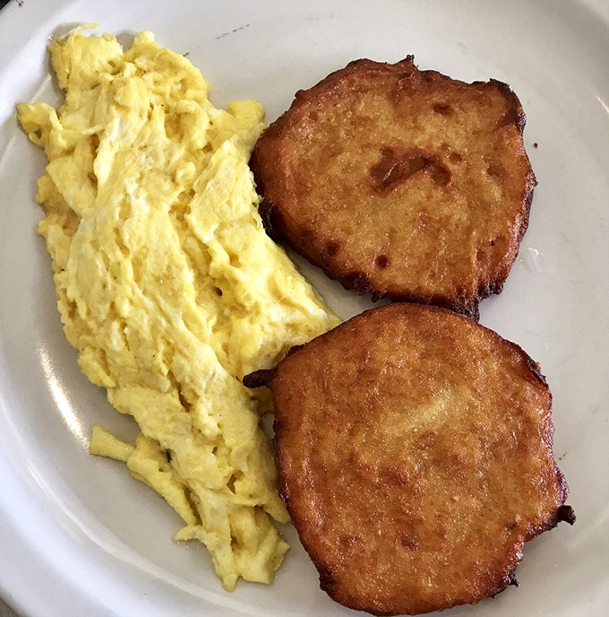 Potato pancakes with a golden crust that sings with each bite, paired with eggs so perfectly scrambled they deserve their own morning talk show.