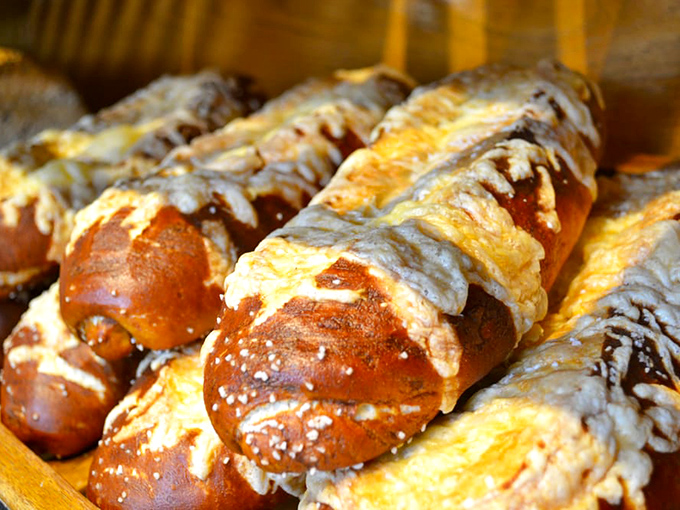 These pretzel rolls have the kind of mahogany shine that would make fine furniture jealous. Carb heaven has never looked so perfectly twisted.