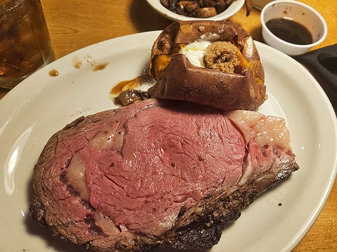 The prime rib arrives like a magnificent island in a sea of possibilities, with that loaded baked potato playing the perfect supporting role.