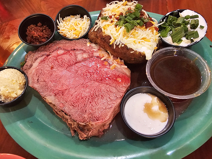 Not all treasures come from the sea. This prime rib arrives perfectly pink with a loaded baked potato&mdash;proof that landlubbers eat royally here too.