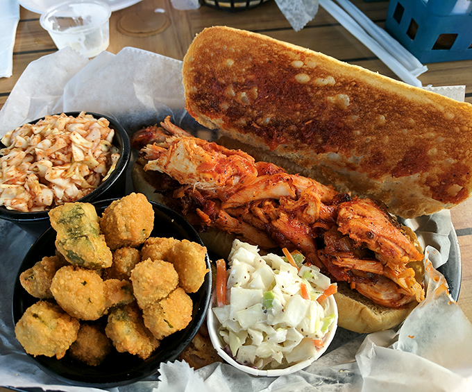 This isn't just a sandwich; it's an architectural marvel of pulled pork, slaw, and golden bread that demands to be photographed before demolished.