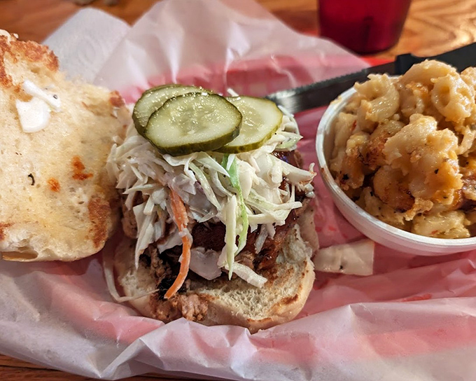 This pulled pork sandwich isn't just a meal; it's an architectural marvel of meat, slaw, and pickles that demands both respect and elastic-waist pants.