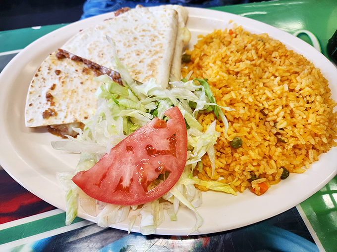 The quesadilla and Mexican rice combo is the comfort food equivalent of a warm hug. That tomato slice adds a pop of freshness.