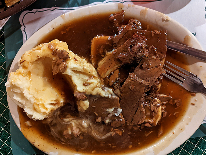Tender roast beef swimming in rich gravy alongside cloud-like mashed potatoes. Comfort food that hugs your soul before it satisfies your stomach.