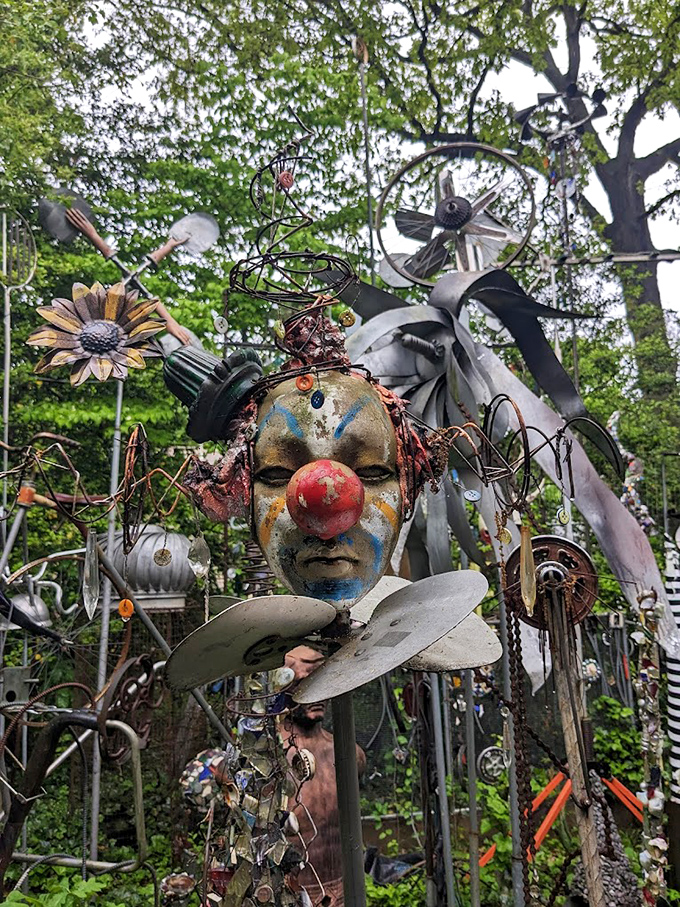 This haunting clown face emerges from the metallic jungle like a carnival dream, simultaneously whimsical and slightly unsettling.