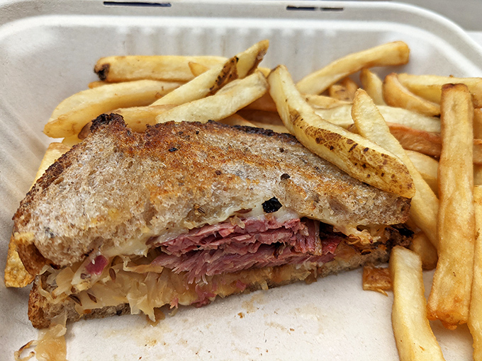 This Reuben isn't just a sandwich, it's an architectural marvel of perfectly balanced corned beef, sauerkraut, and Swiss cheese. Worth every napkin.