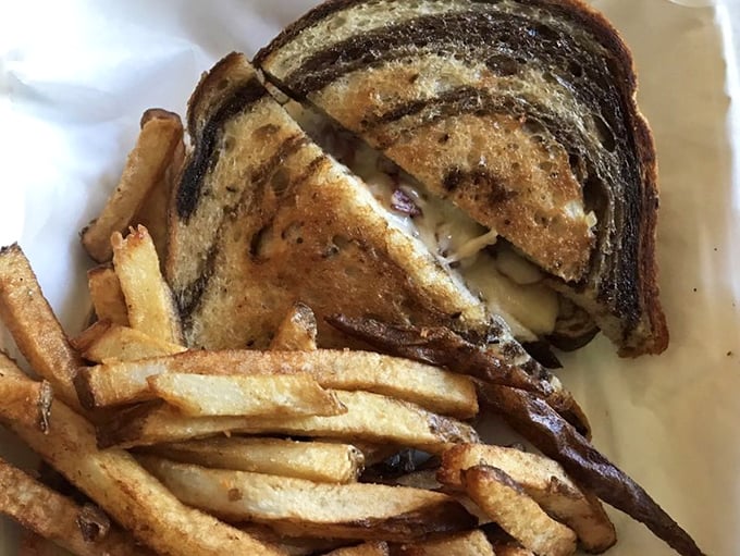 The Reuben arrives like an old friend, perfectly grilled and generously stuffed with all the right ingredients.