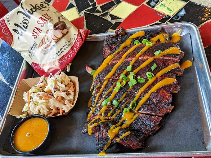 Ribs so perfectly charred and sauced they deserve their own Instagram account. That yellow drizzle isn't just decoration&mdash;it's flavor architecture.