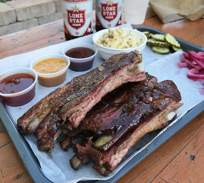 Ribs that would make Fred Flintstone weep with joy, accompanied by sauces that deserve their own fan club.