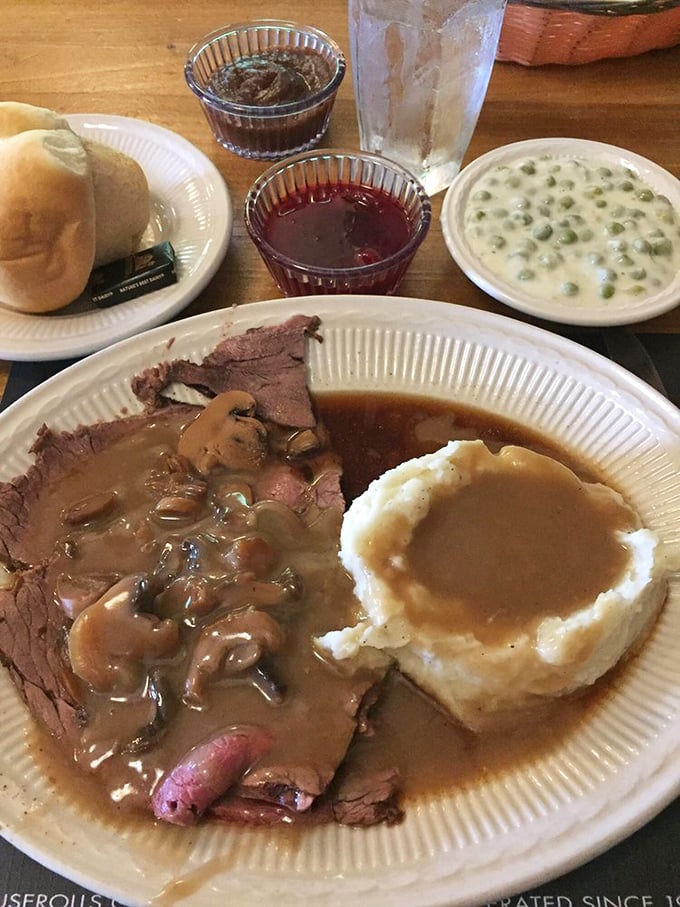 Roast beef so tender it practically surrenders to your fork, swimming in gravy that should be bottled and sold as liquid happiness.