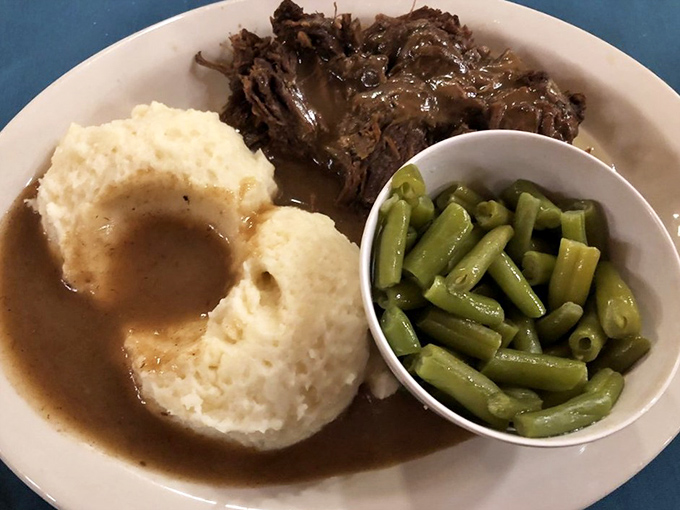 Fork-tender roast beef swimming in rich gravy alongside mashed potatoes and green beans&mdash;the holy trinity of Midwestern Sunday dinners.