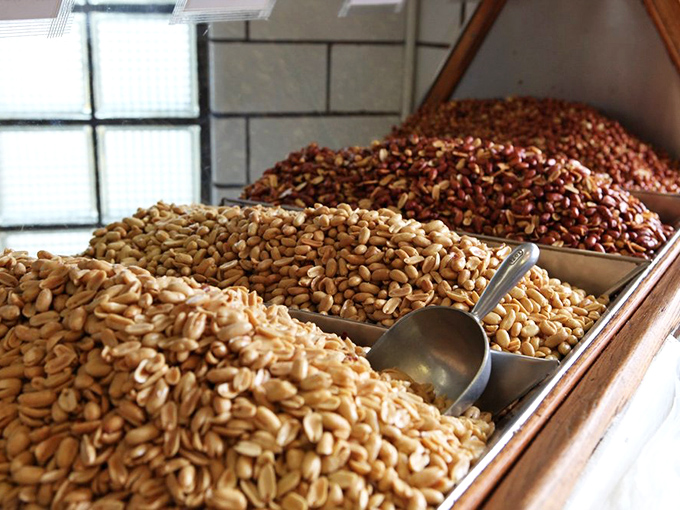 Behold the motherlode&mdash;fresh roasted peanuts awaiting their destiny. Some treasures aren't buried; they're scooped from wooden bins with metal shovels.