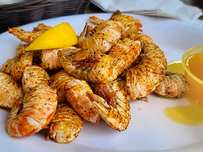 Rock shrimp that look like they're auditioning for a seafood calendar – plump, perfectly seasoned, and posing next to that lemon wedge like they know they're the stars.