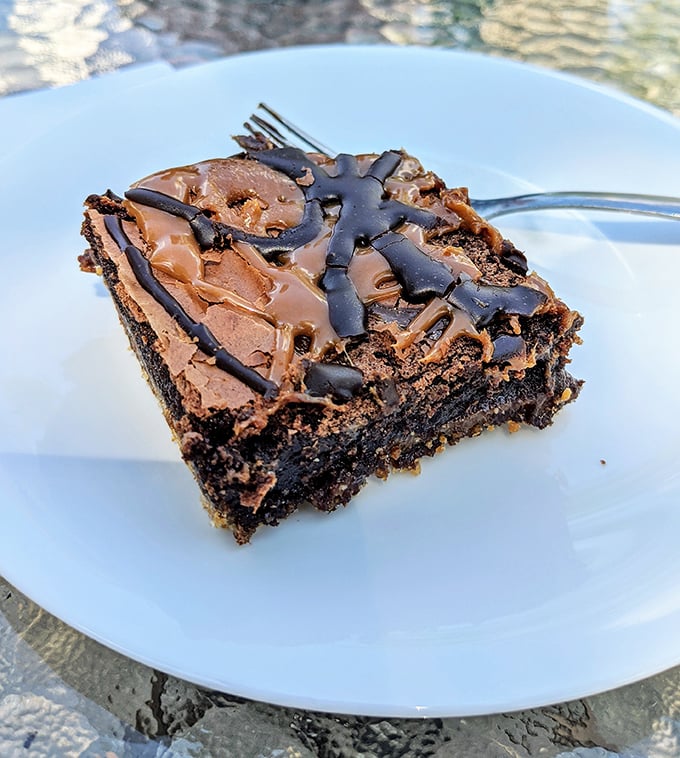 A brownie so decadent it should come with a warning label. That crackly top gives way to fudgy perfection that would make Willy Wonka weep with joy.