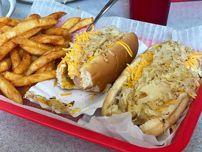 Sauerkraut and cheese elevate these dogs from simple street food to Midwestern masterpieces. The crispy fries are non-negotiable companions.