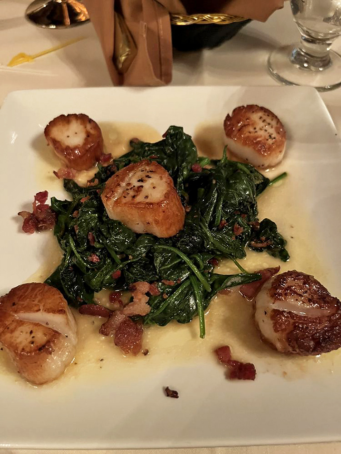 Perfectly seared scallops nestle atop fresh spinach, creating a dish that's both restaurant-fancy and soul-satisfying delicious.