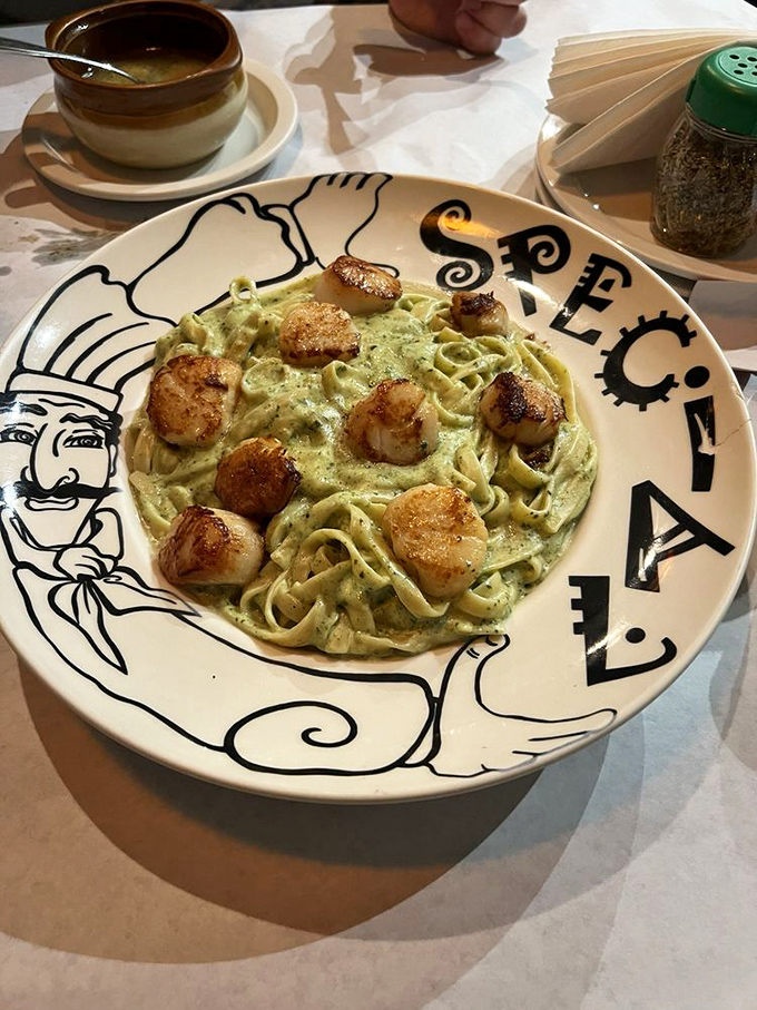 Pasta perfection meets seafood splendor. These golden-seared scallops nestled atop creamy pesto fettuccine might make you forget deep dish exists.