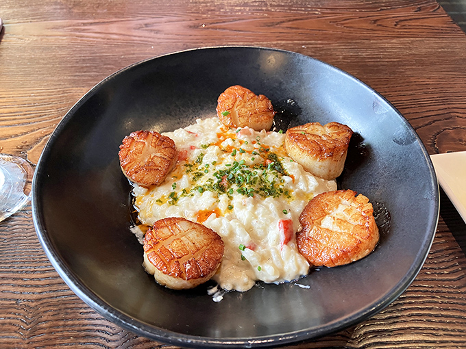 Perfectly seared scallops stand guard around a creamy risotto fortress—a seafood arrangement so pretty it almost makes you feel guilty. Almost.