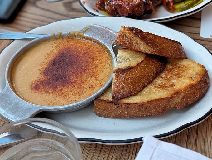 The Scotch rarebit arrives with toast points so perfectly golden they deserve their own spotlight. Dip, bite, and prepare to swoon.