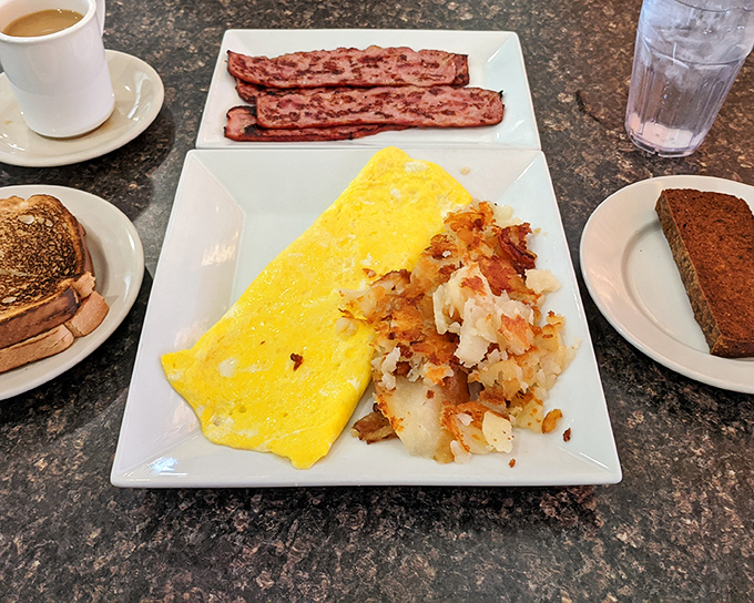 Breakfast perfection on a plate: fluffy scrambled eggs, crispy bacon, and hash browns that achieve that magical crisp-yet-tender balance.