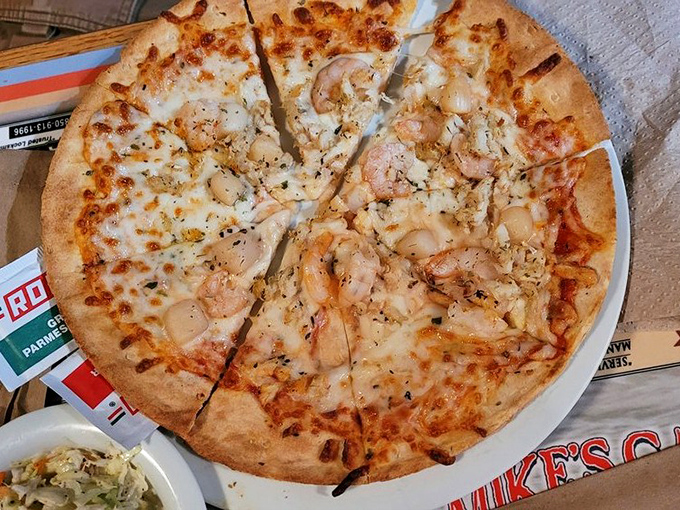 The seafood pizza&mdash;where Italian tradition meets Gulf Coast abundance. Those plump shrimp aren't just toppings; they're the main event.