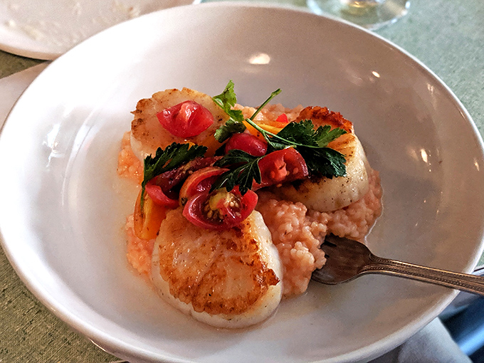 These seared scallops aren't just cooked&mdash;they're caramelized to golden perfection, resting on a cloud of creamy risotto like ocean treasures.