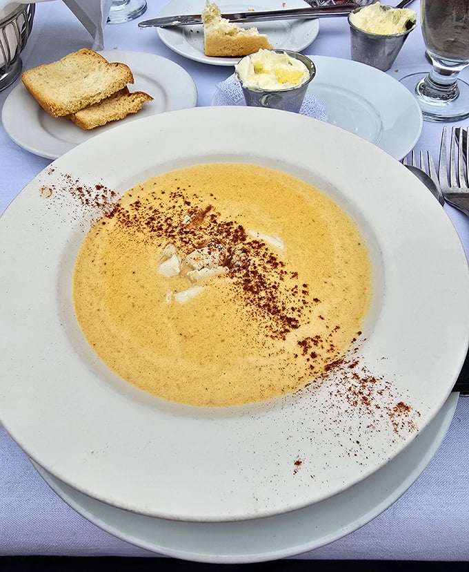 This she-crab soup isn't just a dish; it's a warm, velvety hug in a bowl with a sprinkle of Old Bay wisdom.