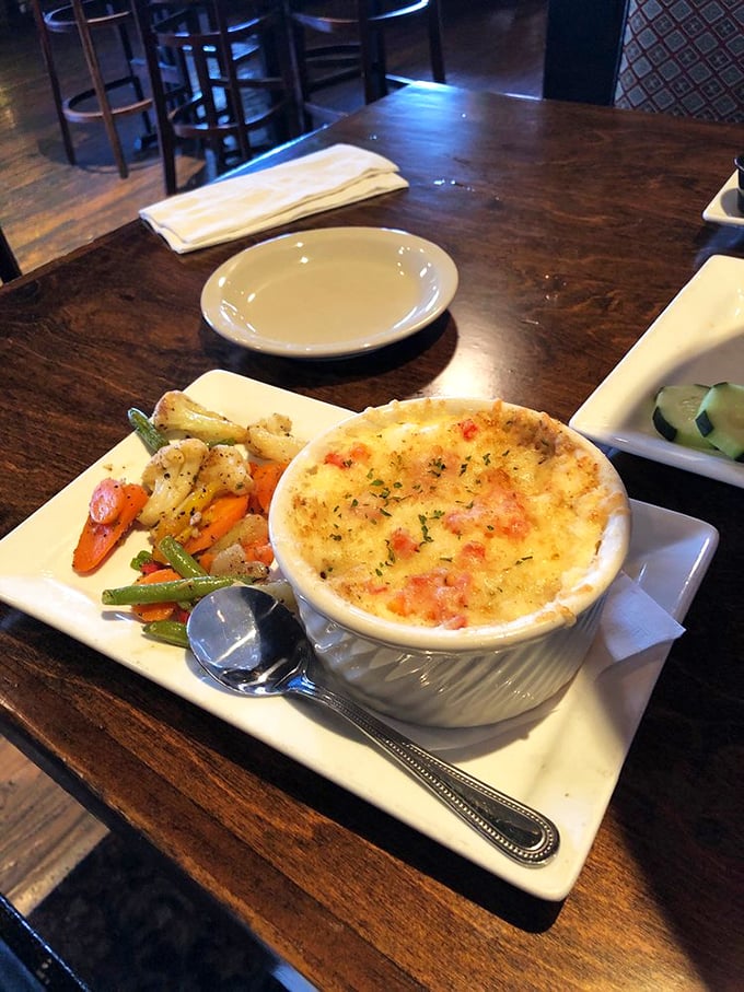 The colorful vegetables alongside prove that even comfort food can dress up for the occasion beautifully.