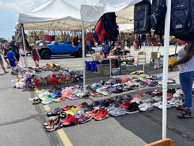 Summer's unofficial starting line: hundreds of sneakers waiting for new adventures, arranged with the precision of a colorful sidewalk art installation.