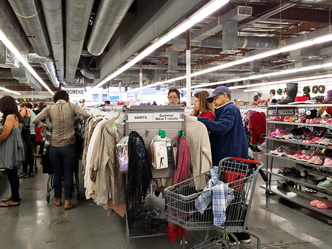 The universal thrift store dance&mdash;shoppers carefully examining potential treasures. That focused concentration is the mark of serious bargain hunters at work.