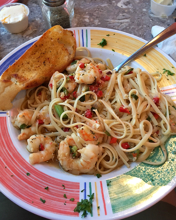 Shrimp scampi that's having a love affair with linguine. The garlic butter sauce is practically begging to be sopped up with that toasted bread.