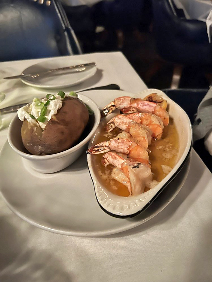 Plump shrimp swimming in butter alongside a loaded baked potato &ndash; the kind of surf and turf pairing that makes cardiologists wince and diners smile.