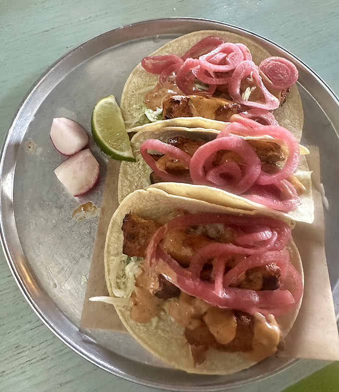 These tacos aren't just topped with pickled onions—they're crowned with them, like royalty of the coastal Mexican food kingdom.