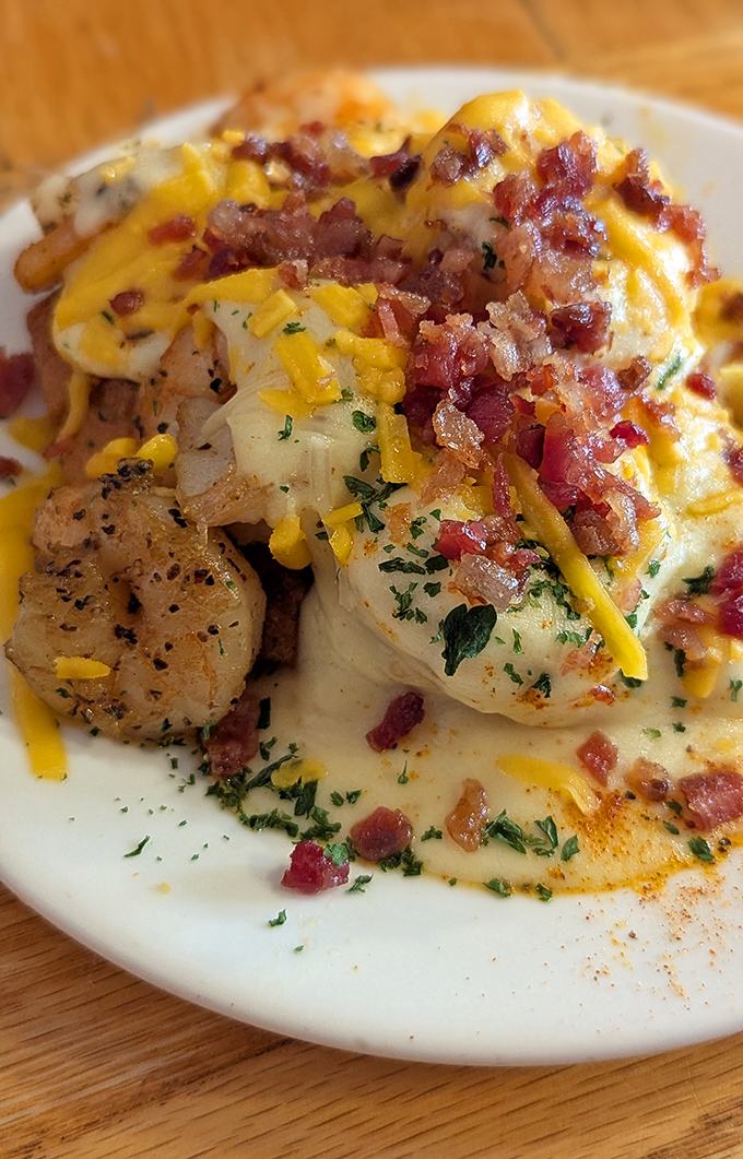 Shrimp and grits get the royal treatment with bacon, cheese, and enough flavor to make your taste buds stand up and salute.