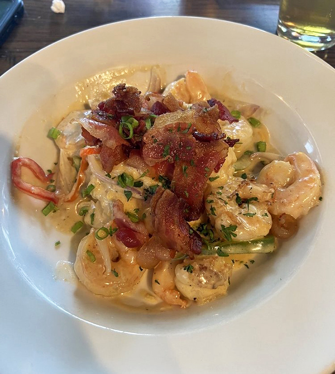 Shrimp and grits elevated to an art form&mdash;creamy, dreamy, and topped with crispy bacon. Southern comfort food that gives actual therapy a run for its money.