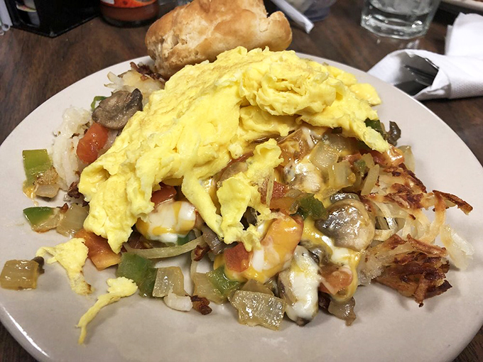 Breakfast architecture at its finest—eggs crowning a foundation of colorful vegetables and crispy potatoes. The Sistine Chapel of morning meals.