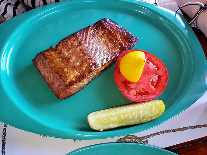 Smoked salmon that glows with amber perfection. The beautiful simplicity of fish, smoke, time, and tradition served with a slice of tomato and pickle.