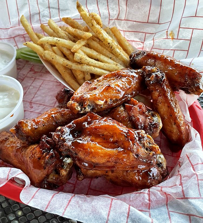 These aren't your average sports bar wings. They're smoke-kissed beauties with a glaze that would make even a vegetarian pause for reflection.