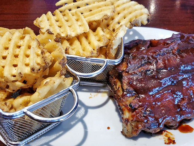 The star of the show: ribs that don't just fall off the bone—they practically leap onto your fork, glistening with that perfect sticky glaze.