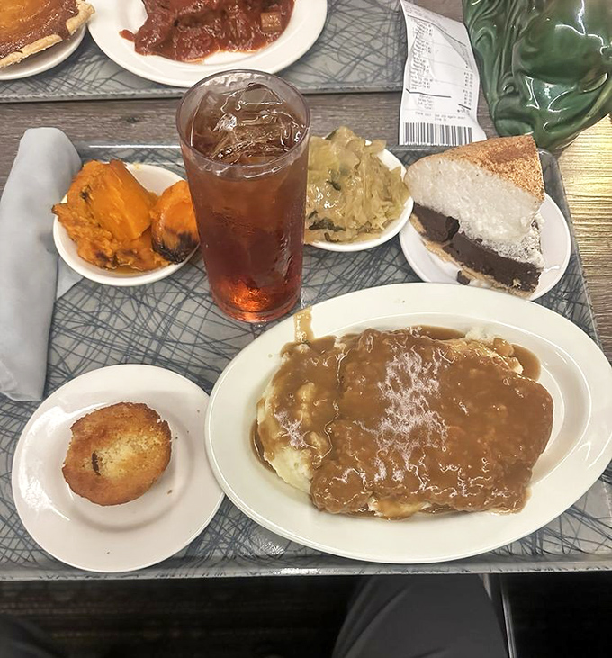 A proper Southern feast: sweet tea, cornbread, and a country-fried steak smothered in gravy that could make even a vegetarian question their life choices.